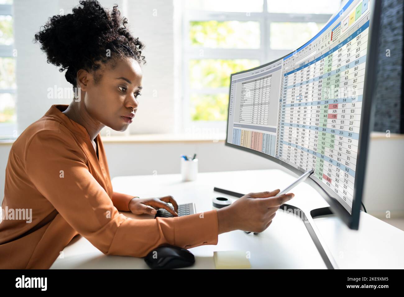Data Analyst African Woman Using Spreadsheet On Computer Stock Photo ...