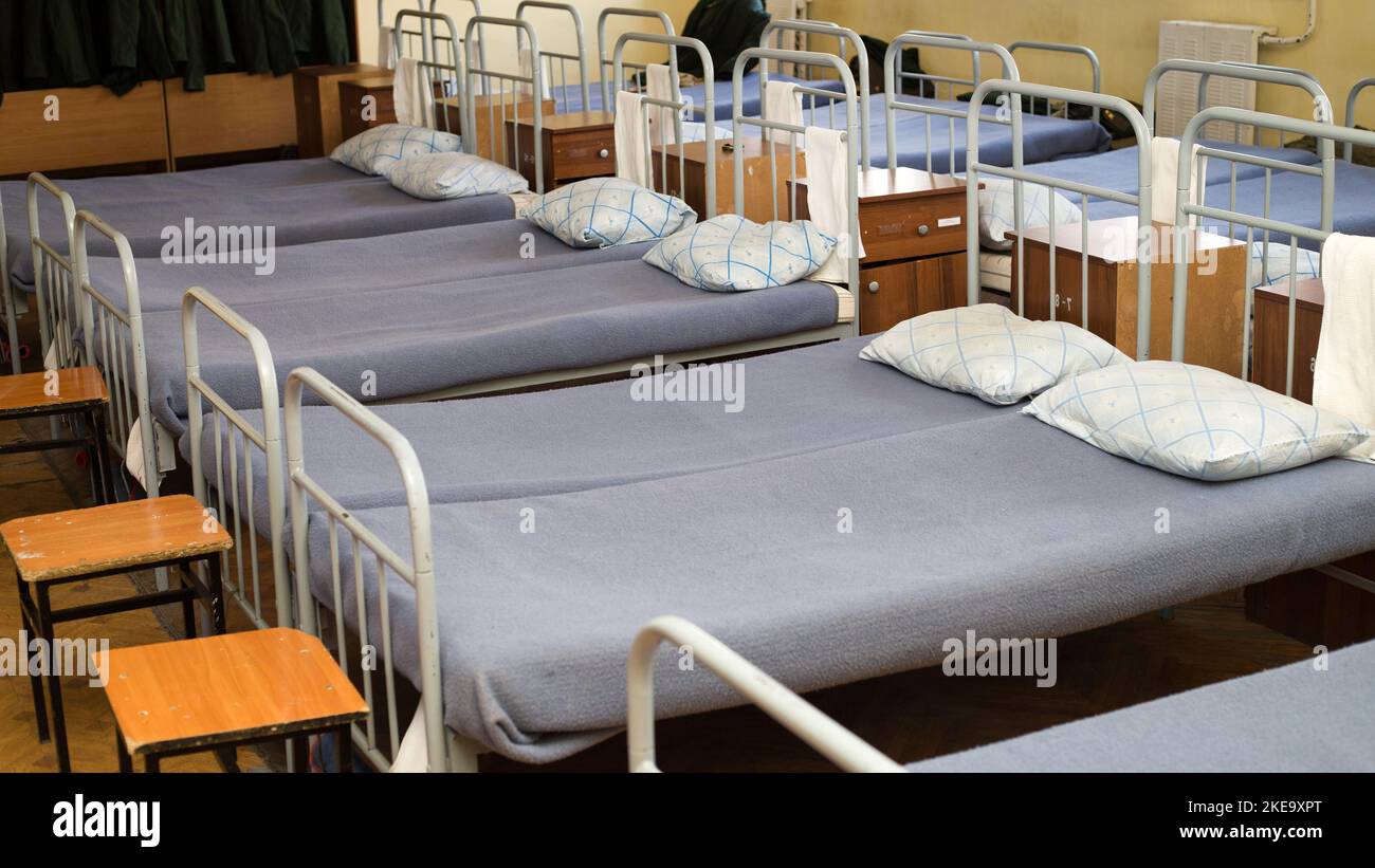 Soldier's beds in the barracks. A row of made beds Russian army, real ...