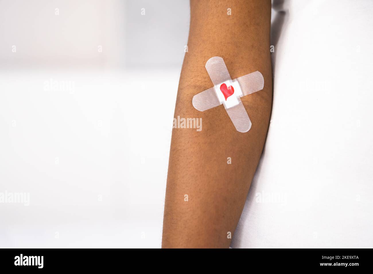 Blood Donation Concept. African American Donor With Band Aid And Heart ...