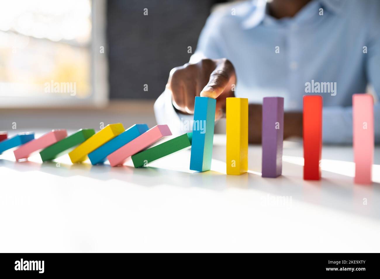 Domino Fall Prevention And Stop Using Hand Stock Photo - Alamy