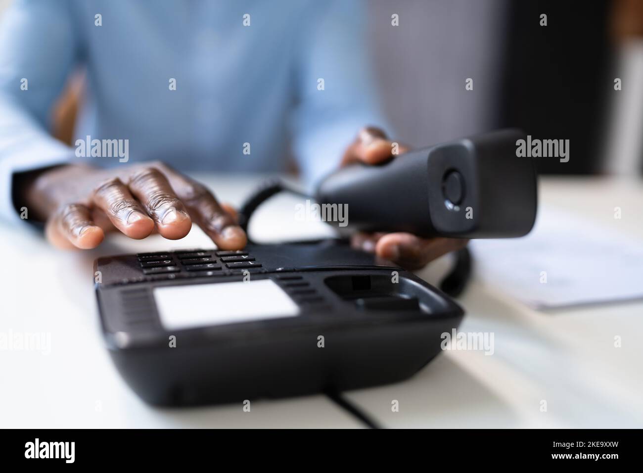 Businessman's Hand Dialing Telephone Number To Make Phone Call In ...