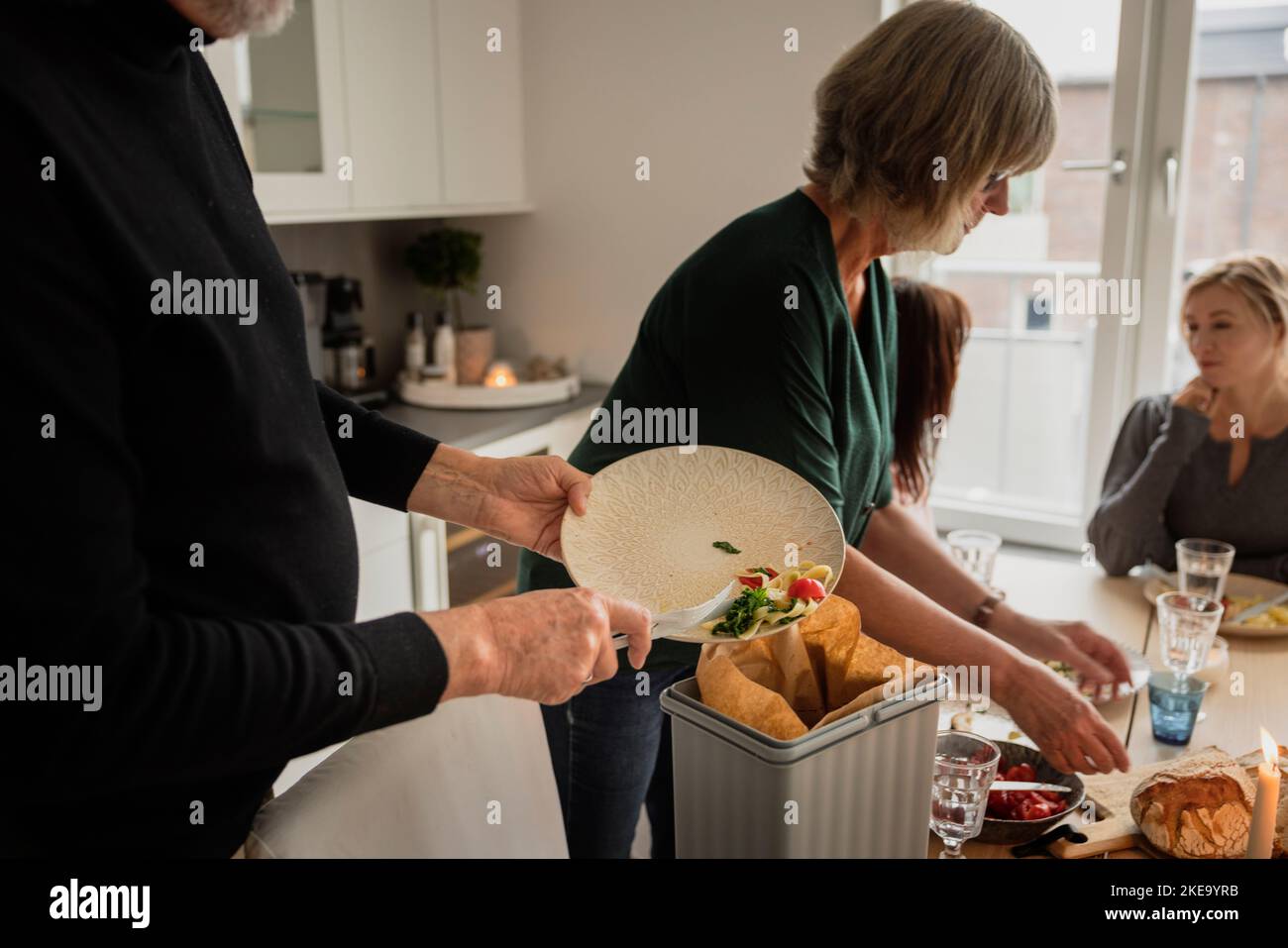 Family cleaning after having dinner Stock Photo - Alamy