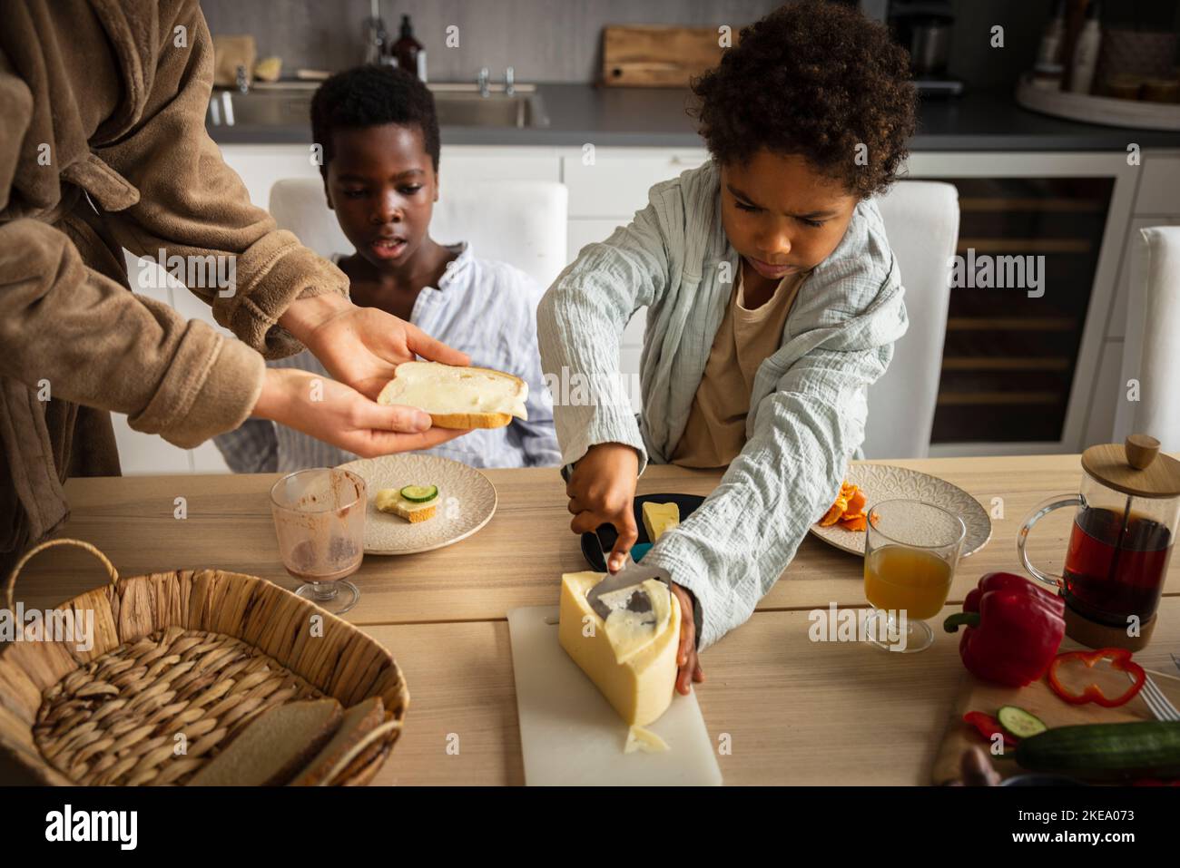 Mother and sons eating breakfast Stock Photo - Alamy