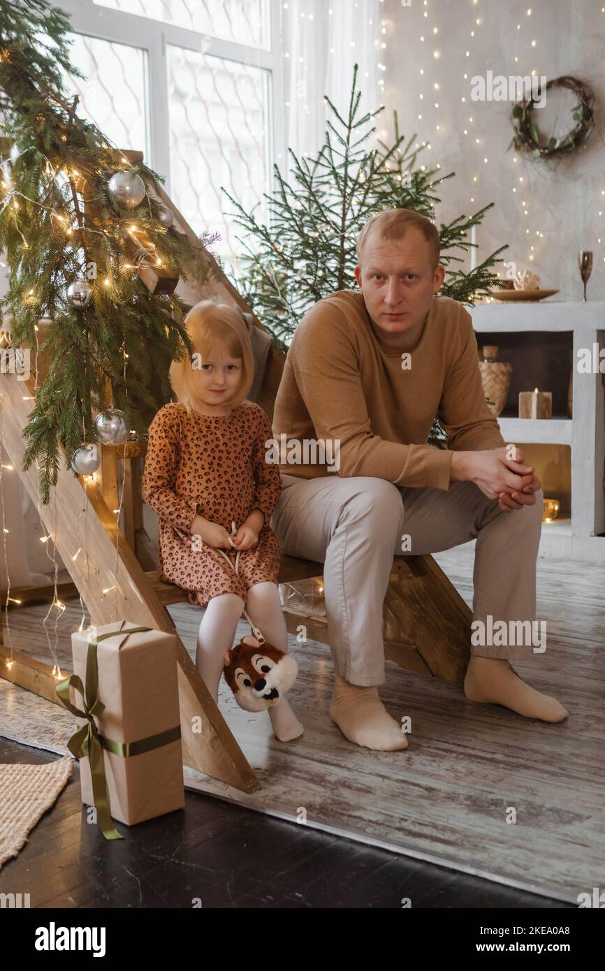 Dad and his little daughter in a magical Christmas atmosphere. The ...