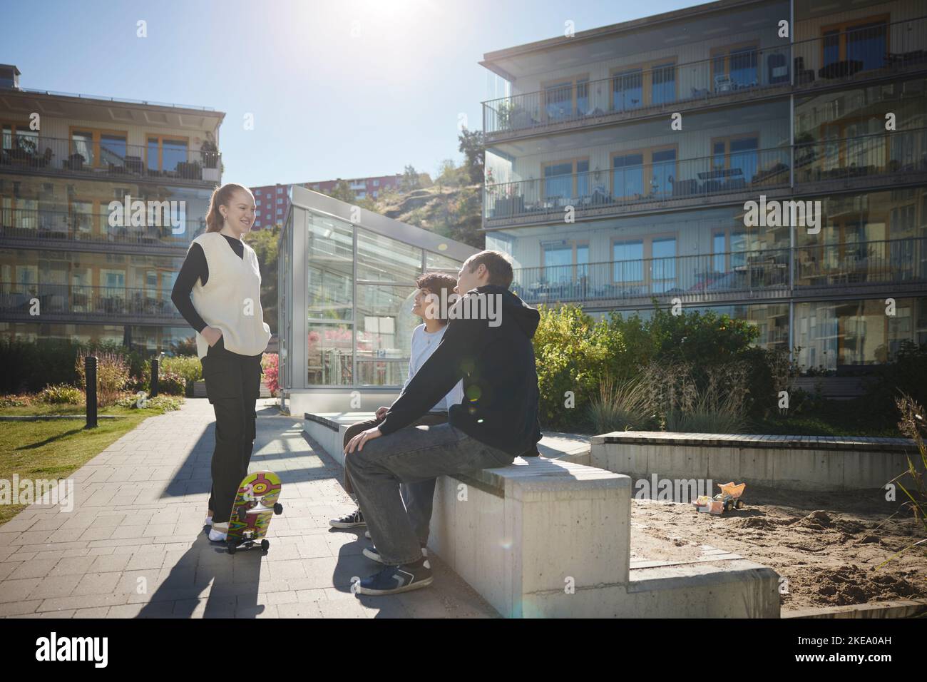 Smiling friends hanging around together Stock Photo - Alamy