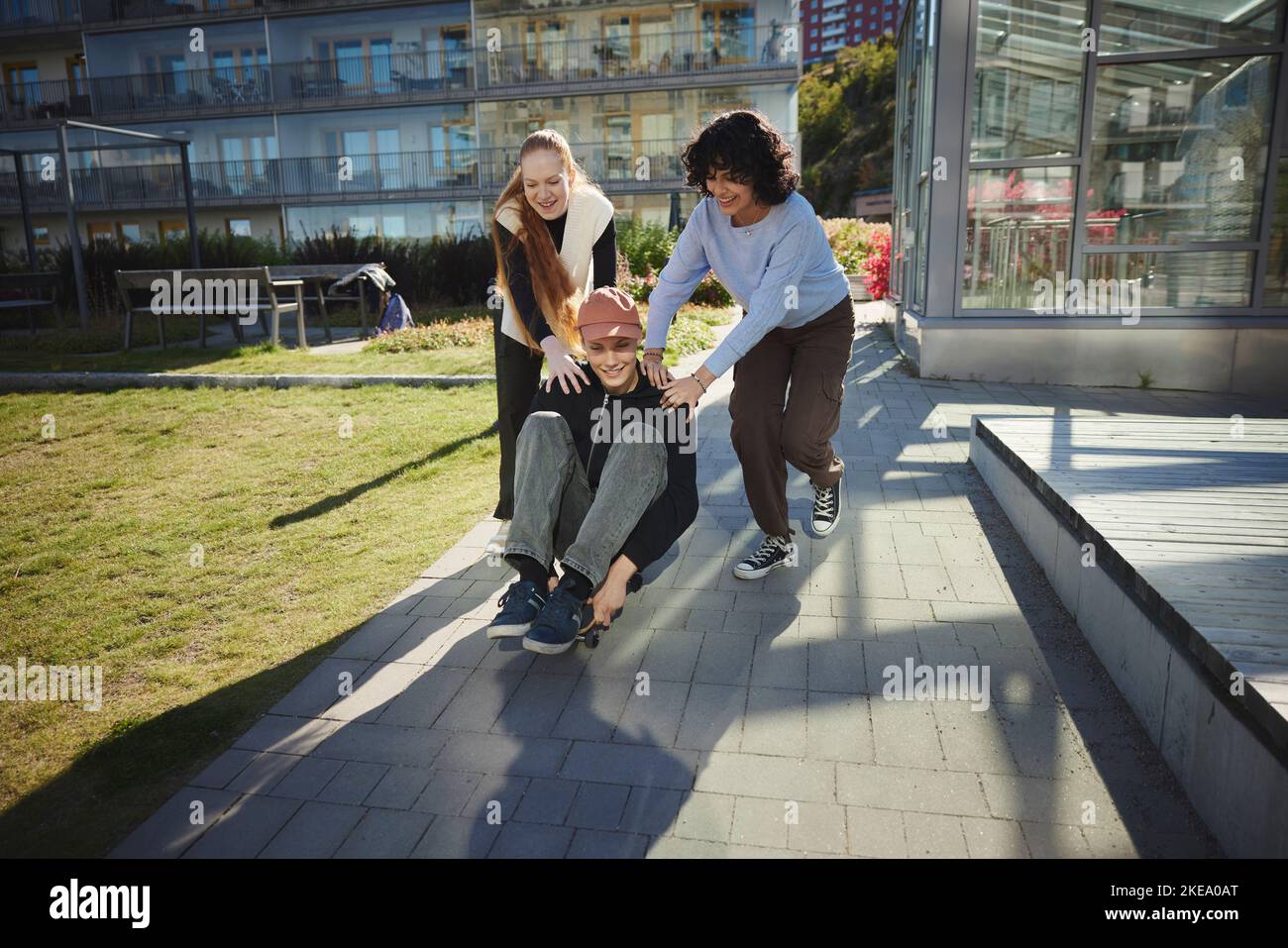 Smiling friends hanging around together Stock Photo - Alamy