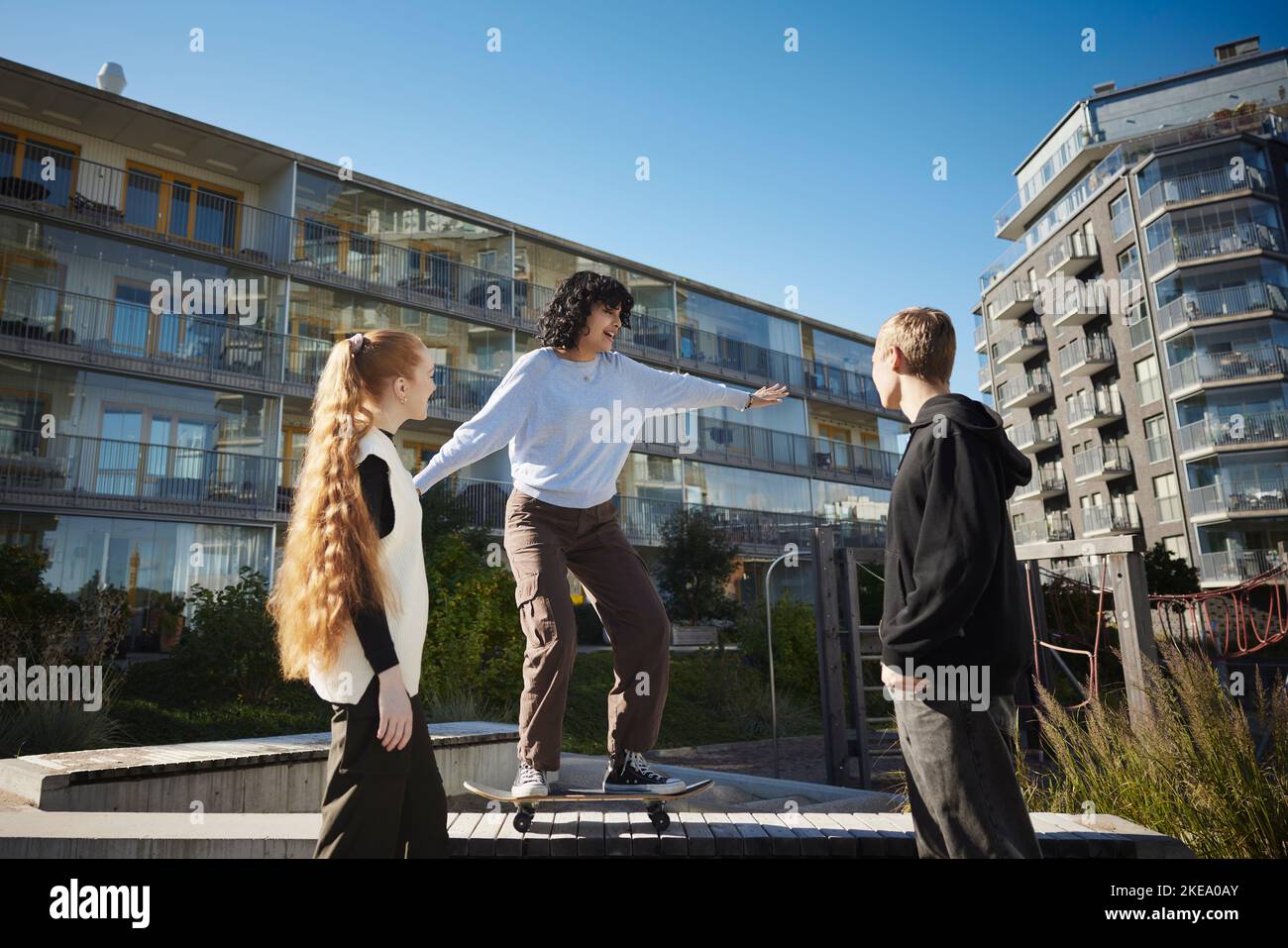 Smiling friends hanging around together Stock Photo - Alamy