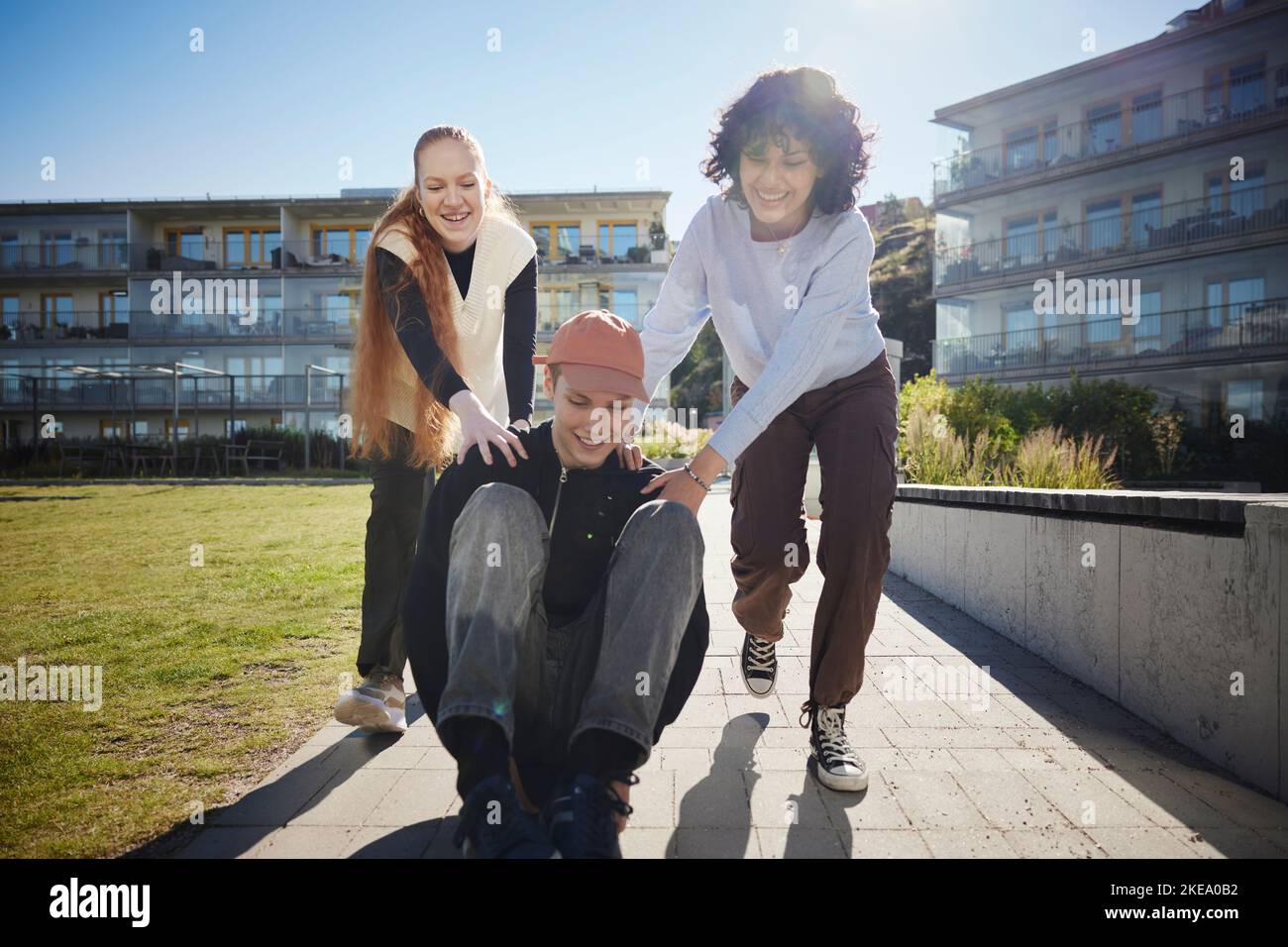 Smiling friends hanging around together Stock Photo - Alamy