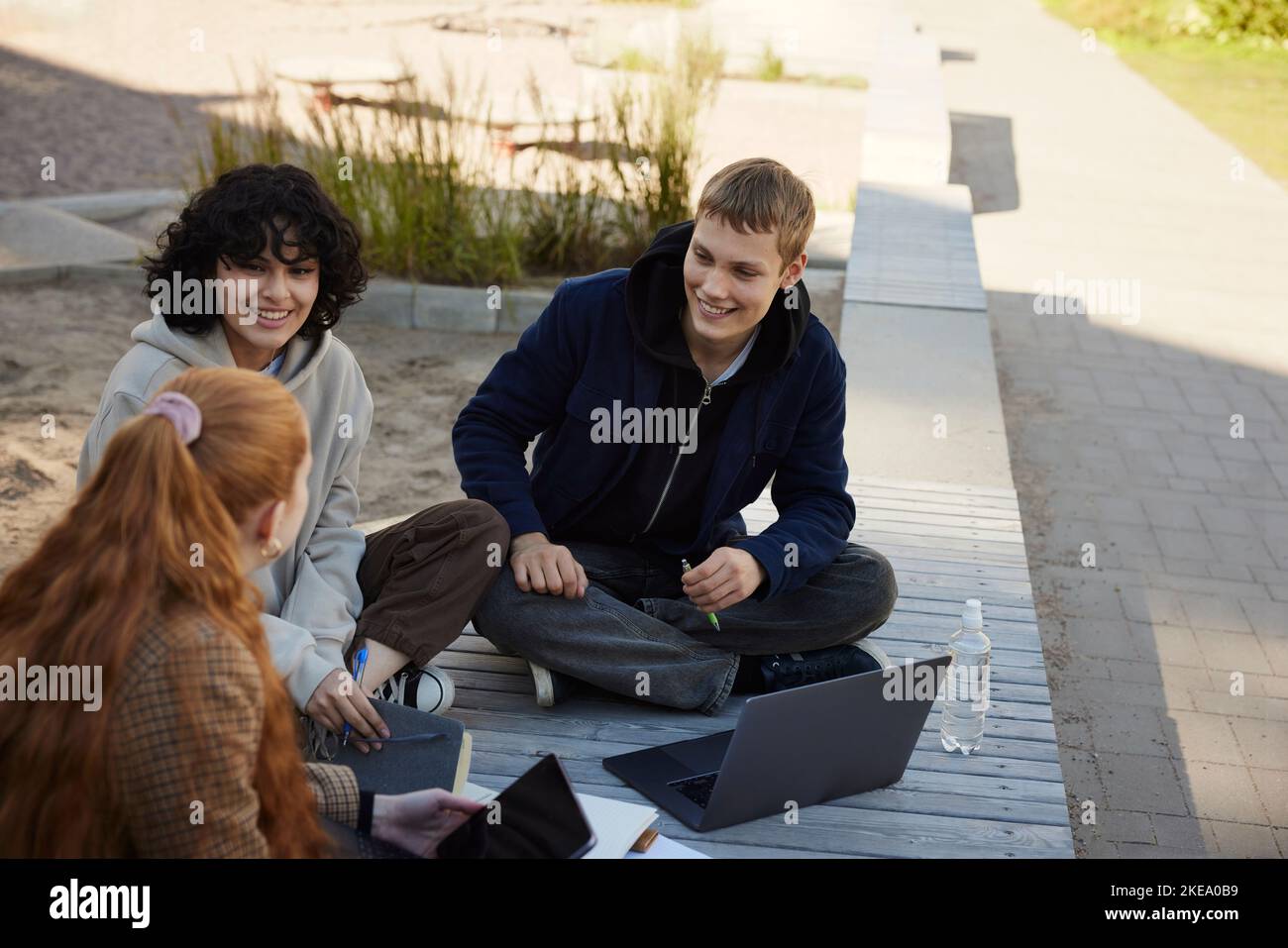 Friends at playground learning Stock Photo - Alamy