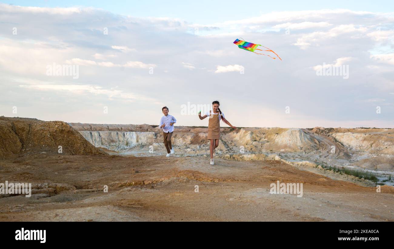 Children play active games with kite outdoors Stock Photo - Alamy
