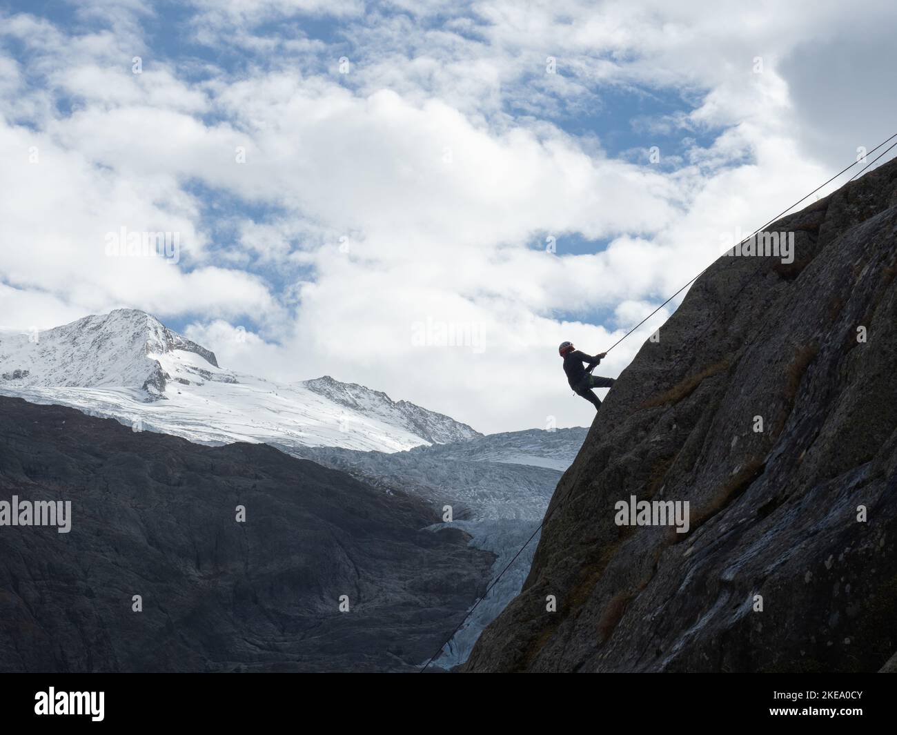 Trift, Switzerland - October 28th 2022: A child being roped from a rock ...