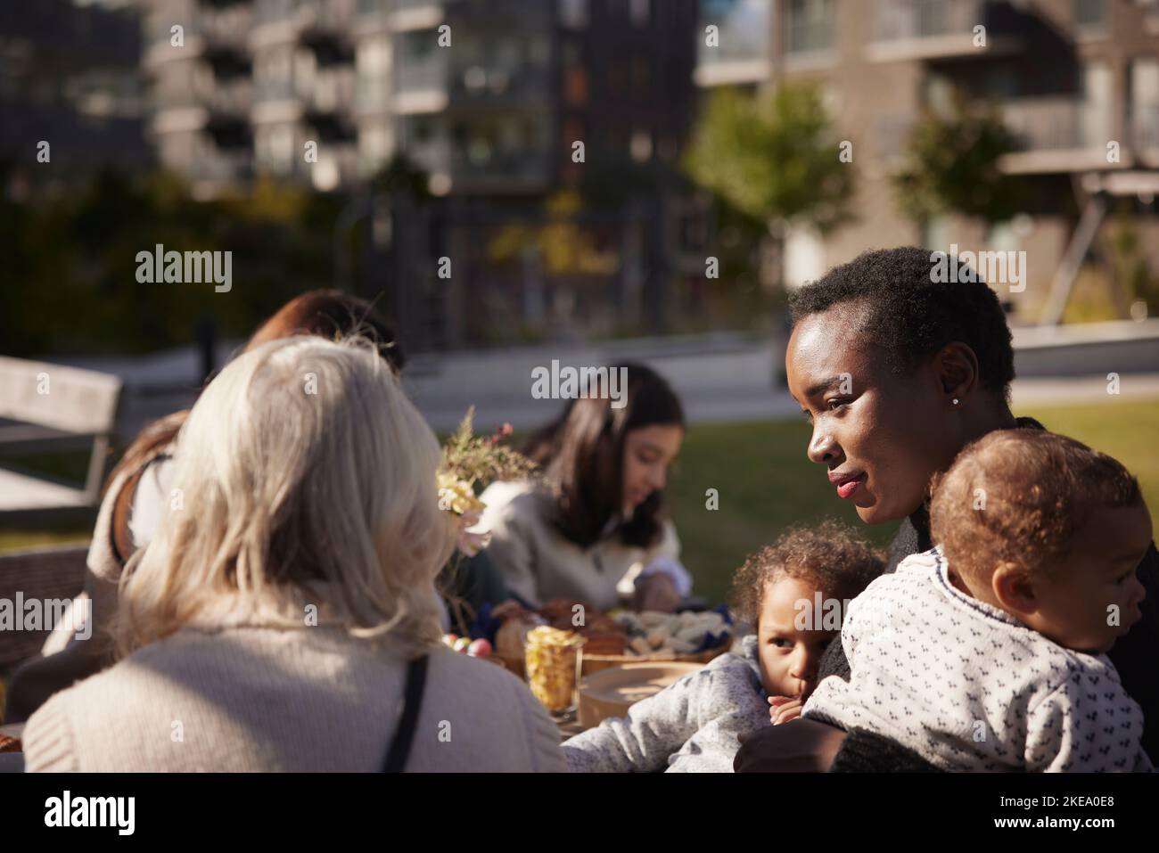 Smiling mother sitting with children Stock Photo - Alamy