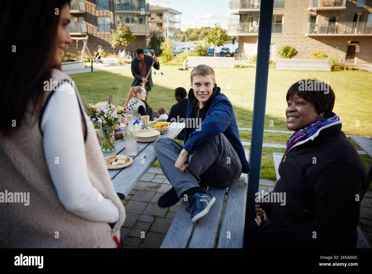 Neighbors relaxing in communal outdoor area Stock Photo - Alamy