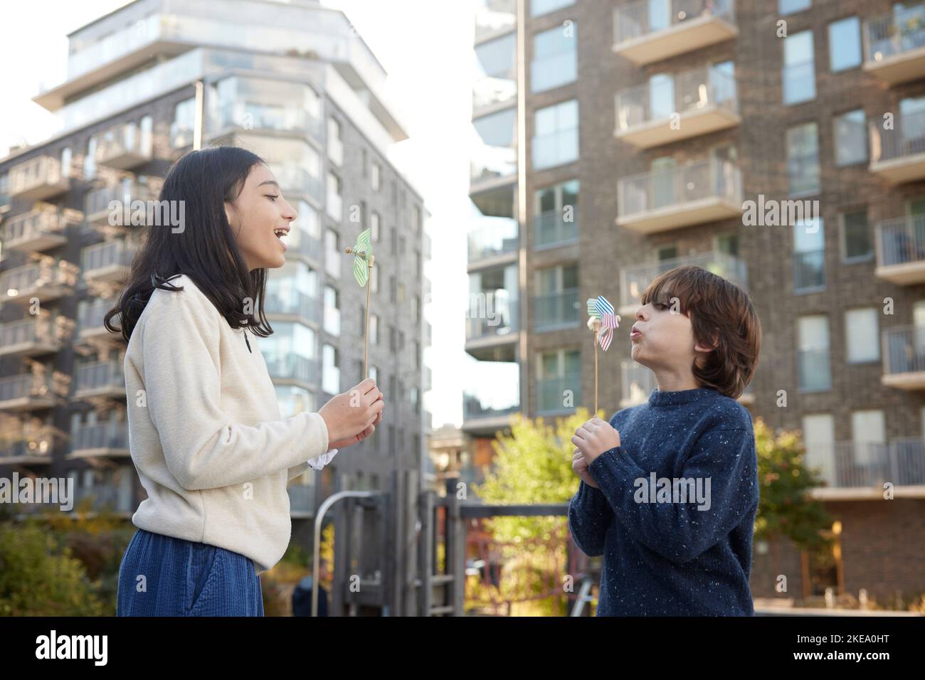 Boy blowing on pinwheel hi-res stock photography and images - Alamy