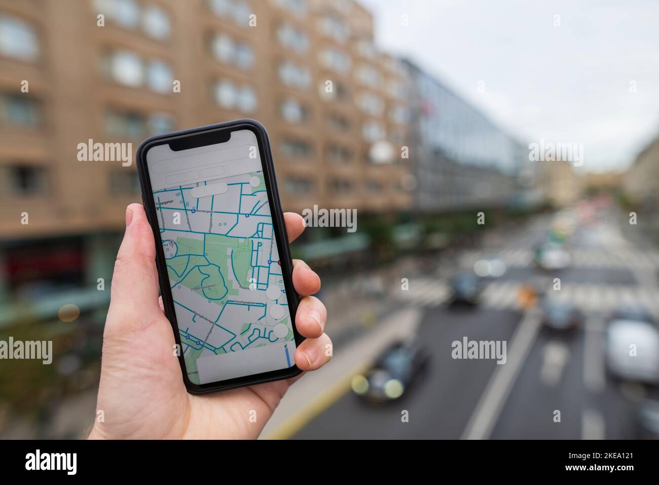 Hand holding smartphone with map app on screen Stock Photo - Alamy