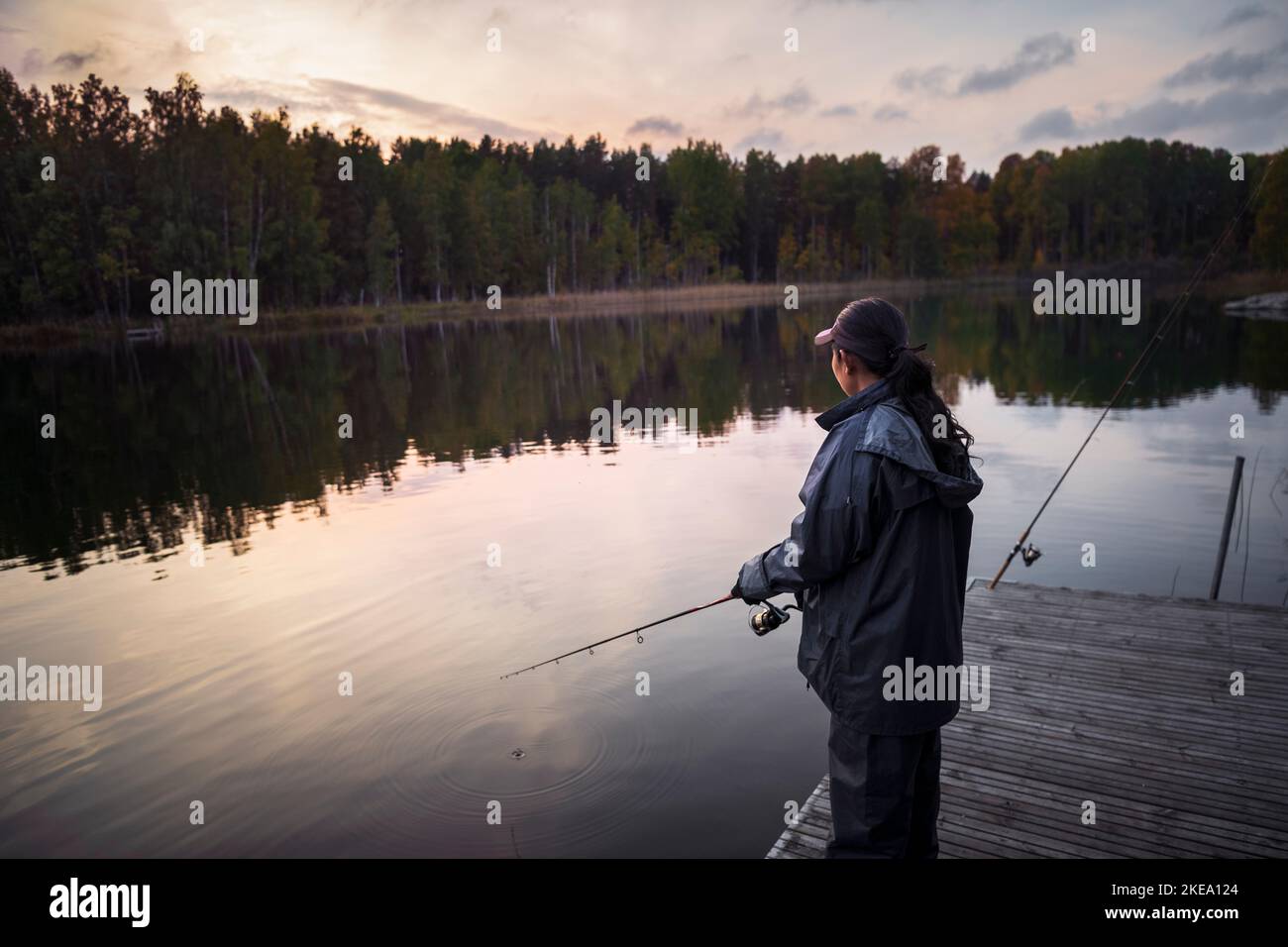Woman standing lake rod hi-res stock photography and images - Alamy