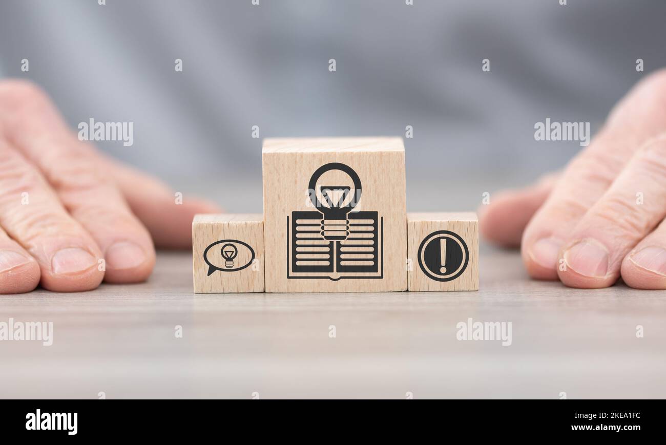 Wooden blocks with symbol of knowledge concept Stock Photo - Alamy