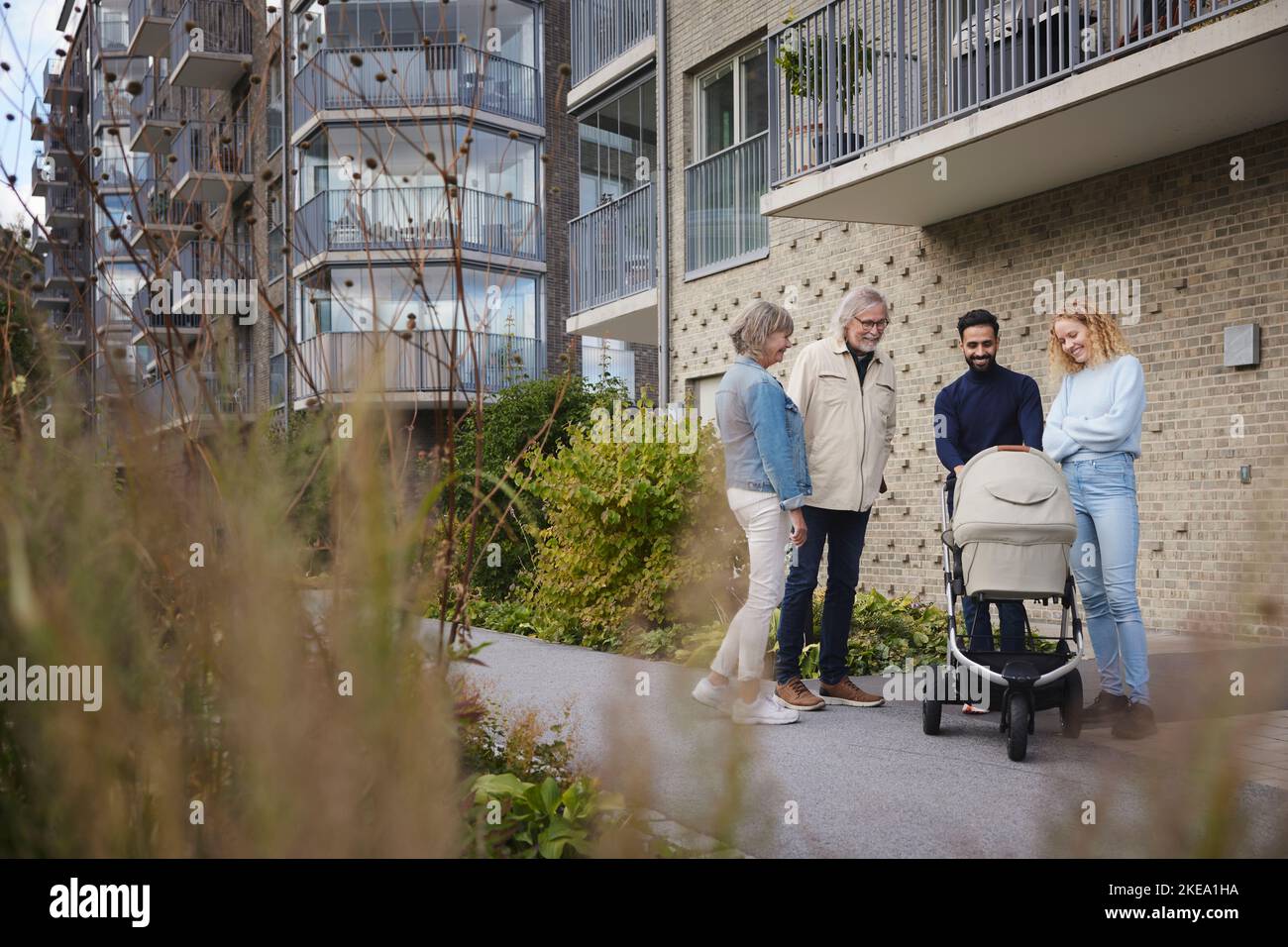 People in front of block of flats Stock Photo - Alamy