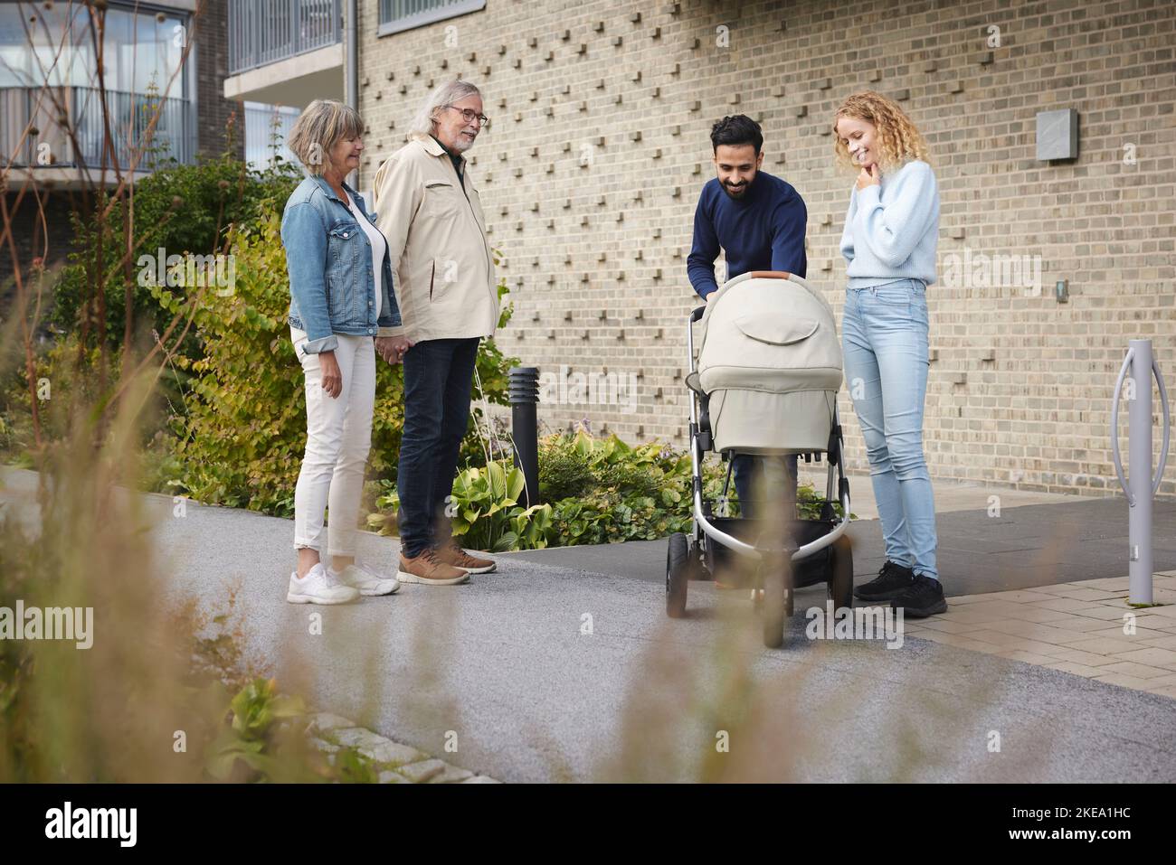 People in front of block of flats Stock Photo - Alamy