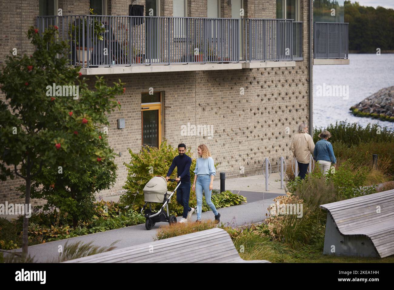 People in front of block of flats Stock Photo - Alamy