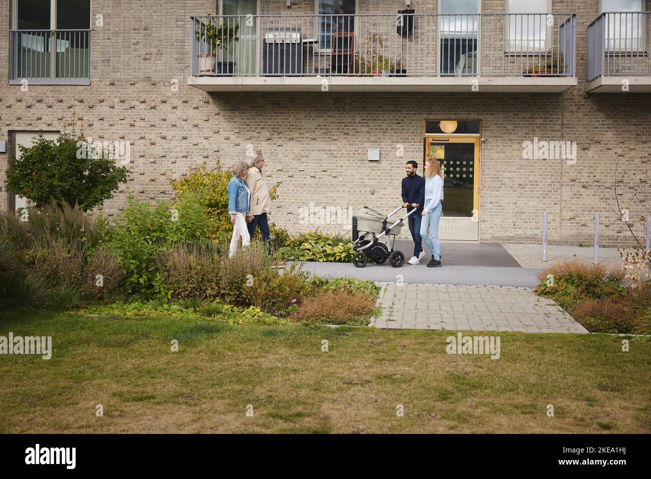 People in front of block of flats Stock Photo - Alamy