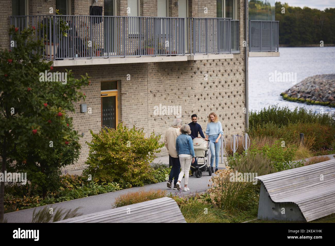 People in front of block of flats Stock Photo - Alamy