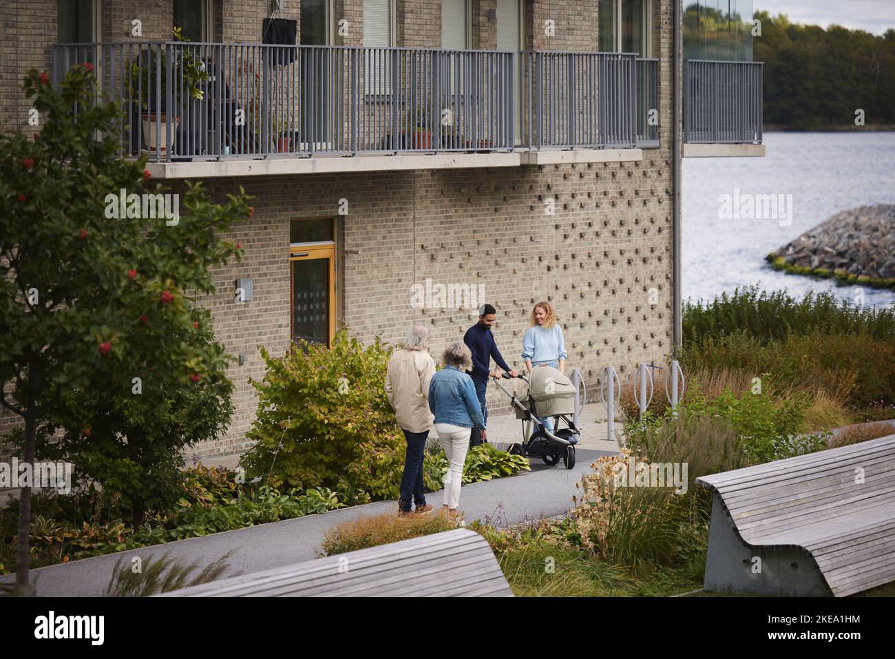 People in front of block of flats Stock Photo - Alamy