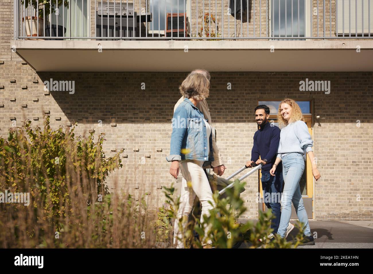 People in front of block of flats Stock Photo - Alamy