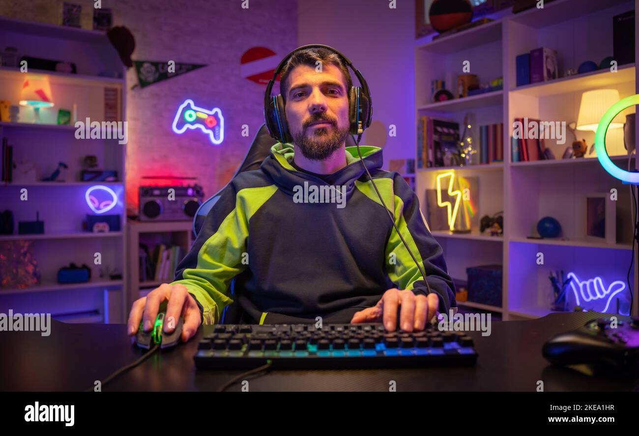 Happy Gamer Portrait Playing Games On The Computer Looking At Camera
