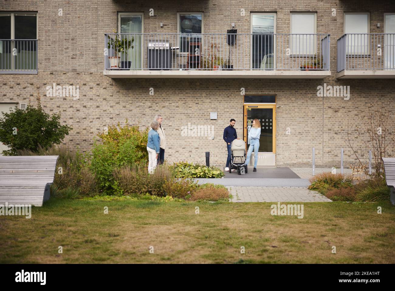 People in front of block of flats Stock Photo - Alamy