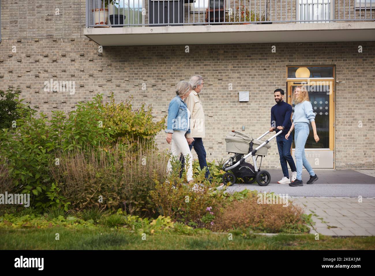 People in front of block of flats Stock Photo - Alamy