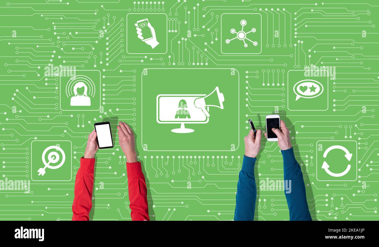 Top view of hands using mobile phone with symbol of influencer concept ...