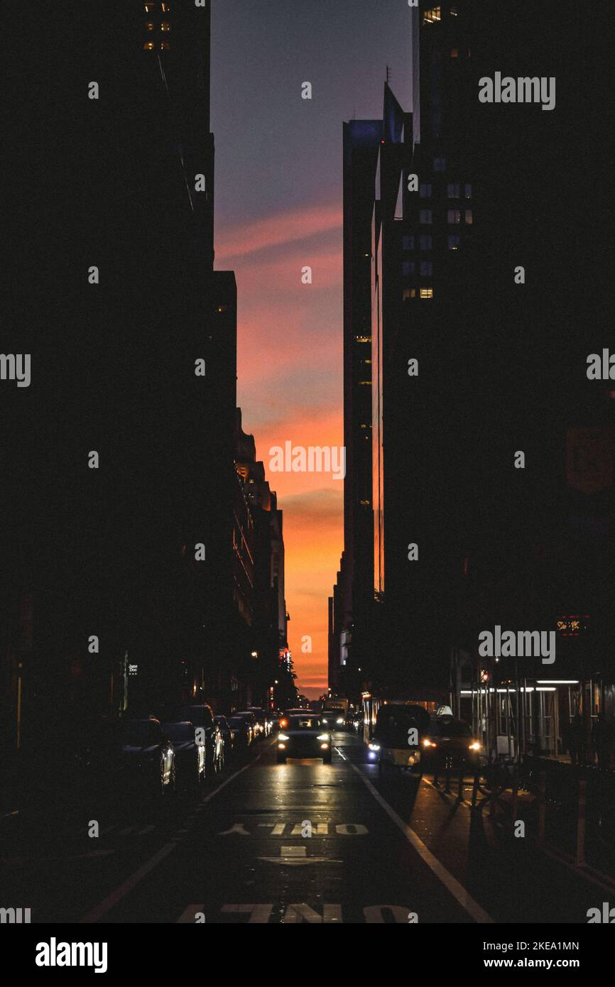 Low angle view of the sunset between city buildings Stock Photo - Alamy