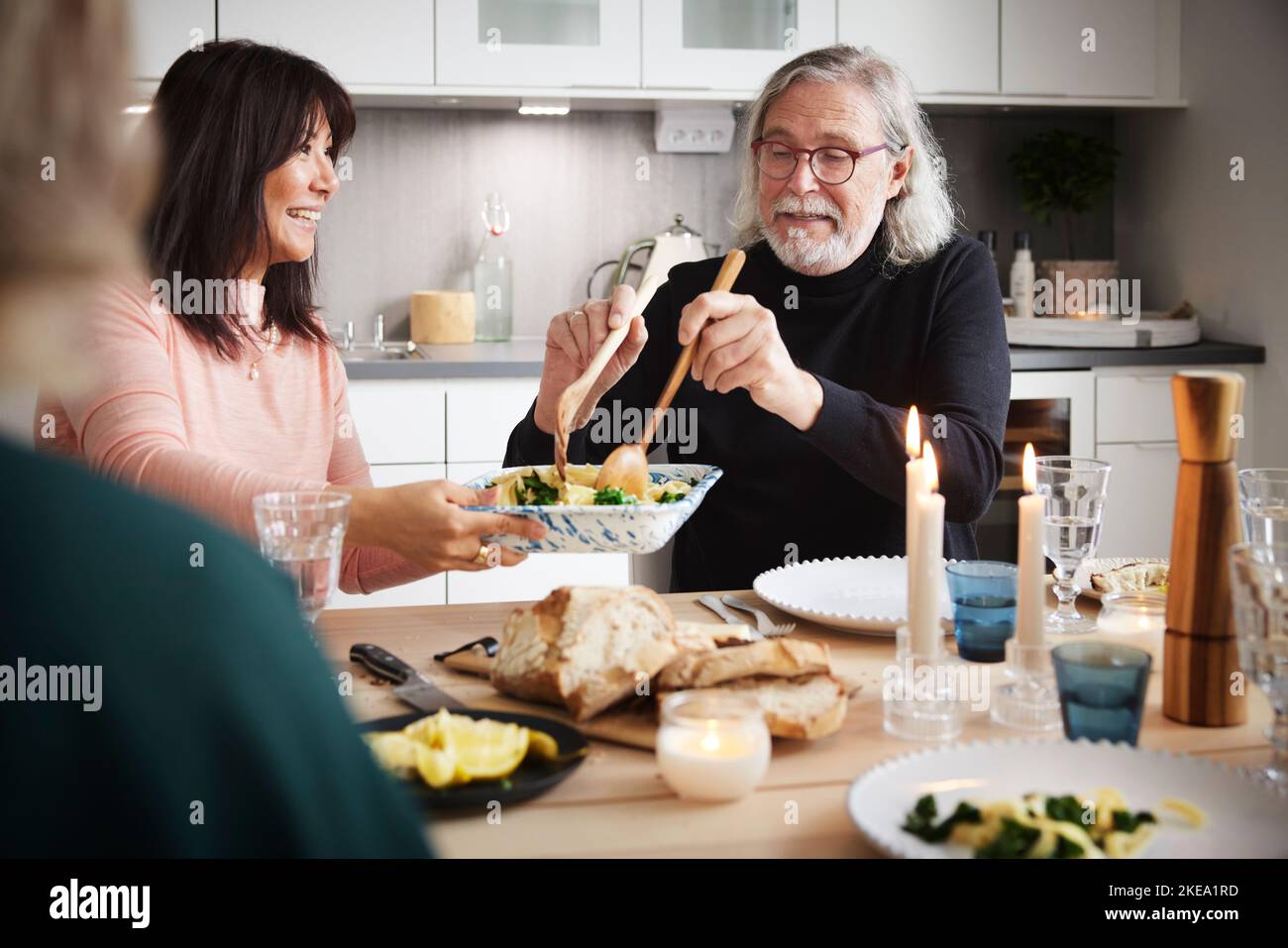 Family eating dinner at home together Stock Photo - Alamy