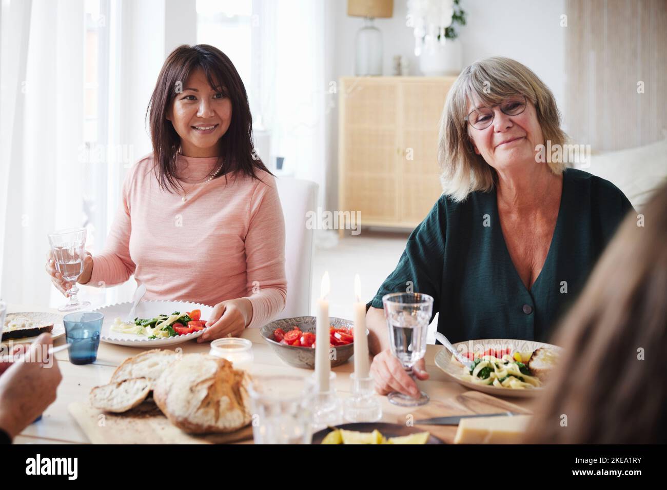 Family eating dinner at home together Stock Photo - Alamy