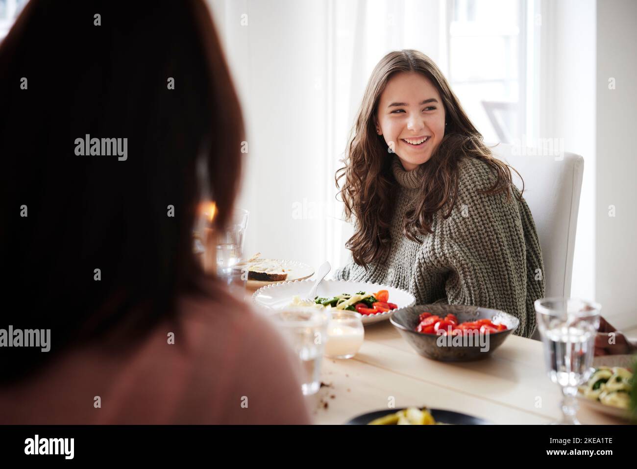 Family eating dinner at home together Stock Photo - Alamy