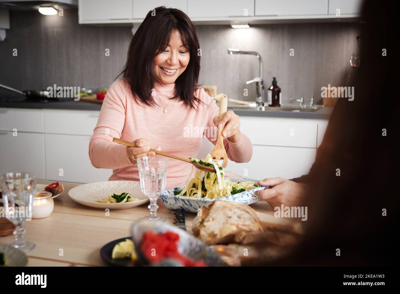 Family eating dinner at home together Stock Photo - Alamy