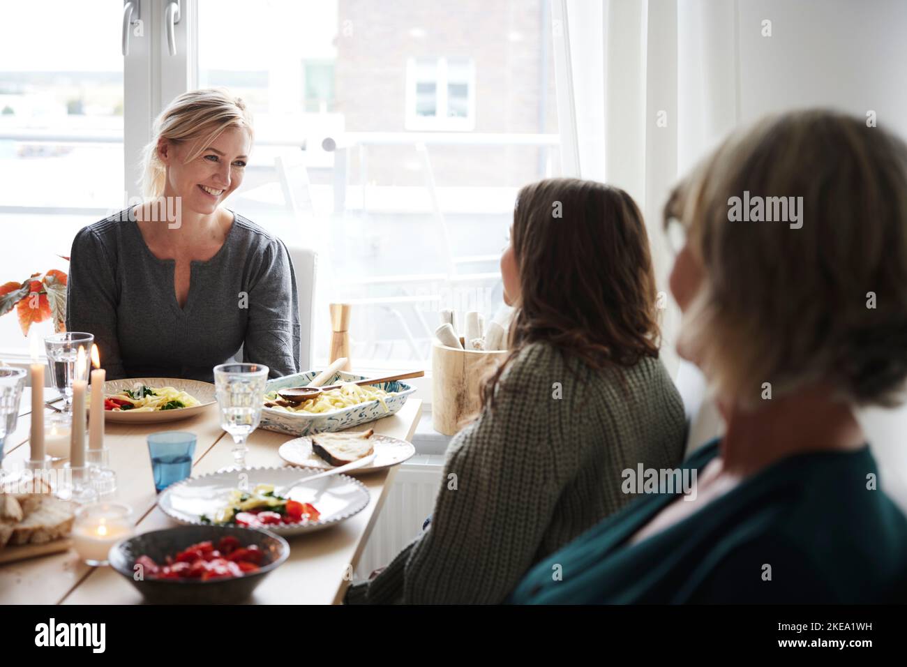 Family eating dinner at home together Stock Photo - Alamy