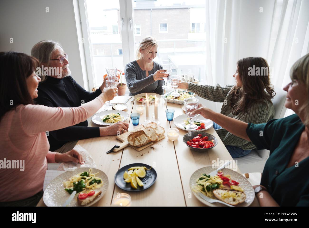 Family raising toast during dinner Stock Photo - Alamy