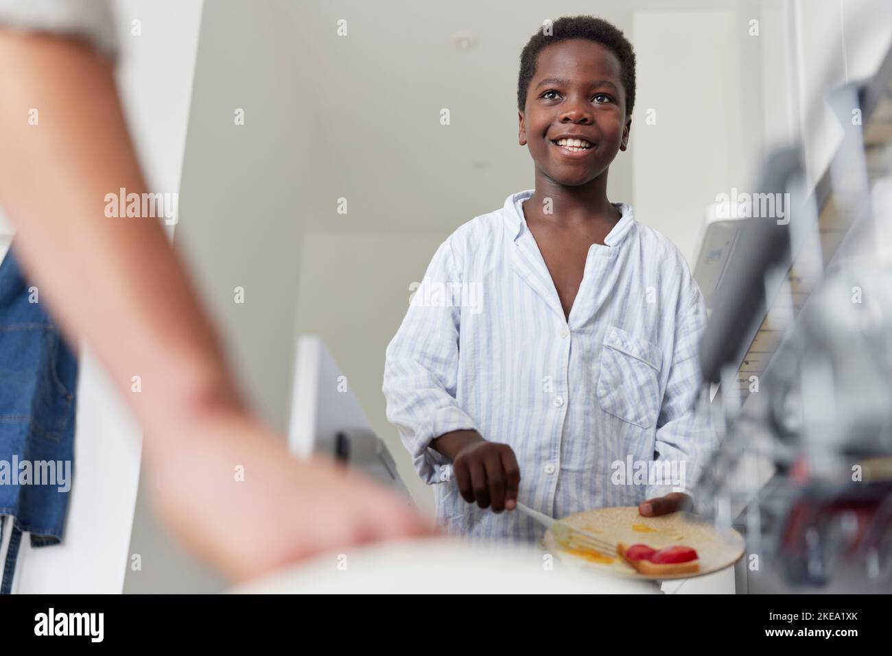 Boy cleaning up after meal Stock Photo - Alamy