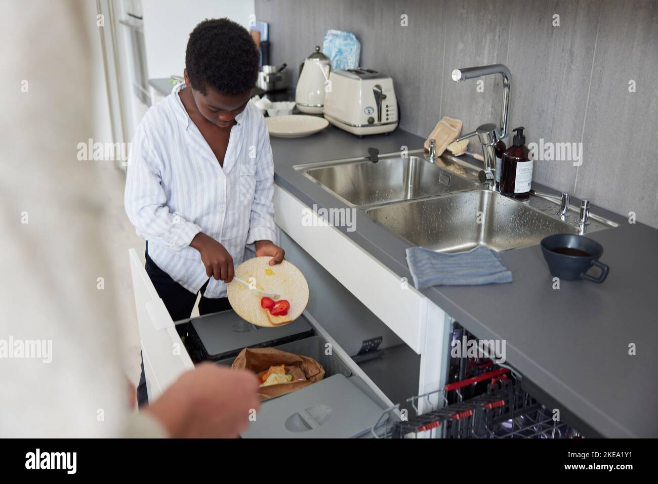Boy throwing out leftover food Stock Photo - Alamy