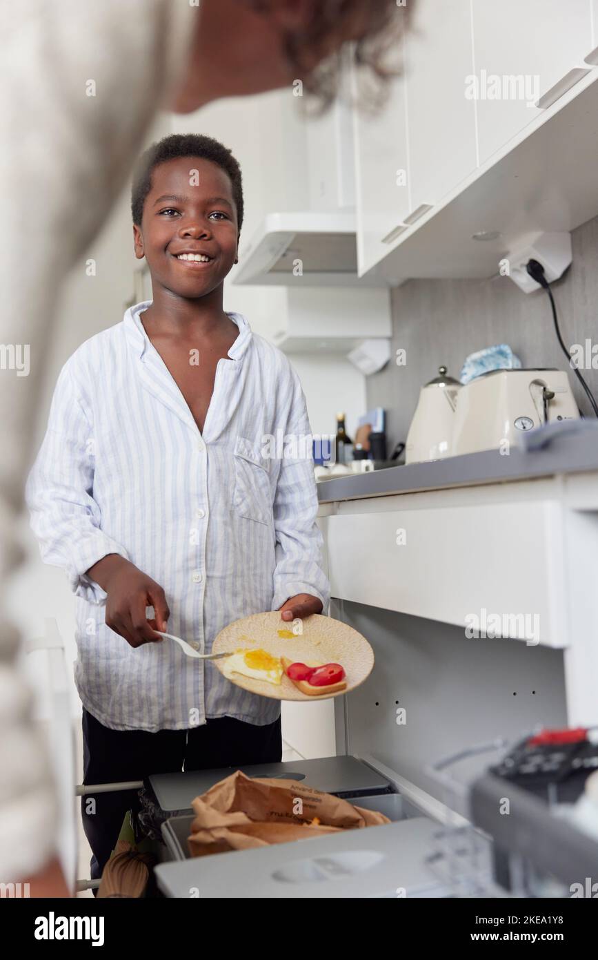 Boy cleaning up after meal Stock Photo - Alamy
