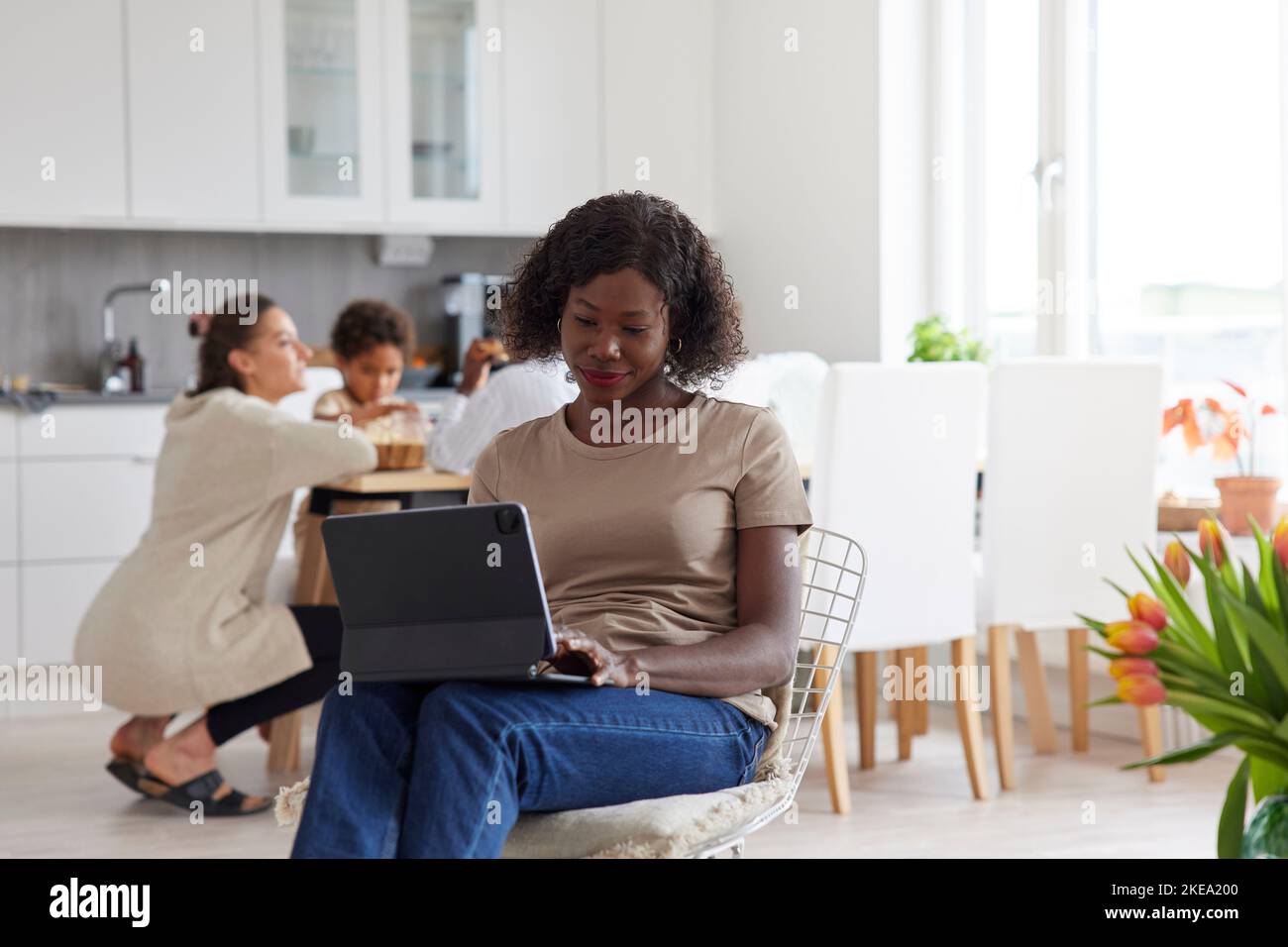 Family working and having meal at home Stock Photo - Alamy