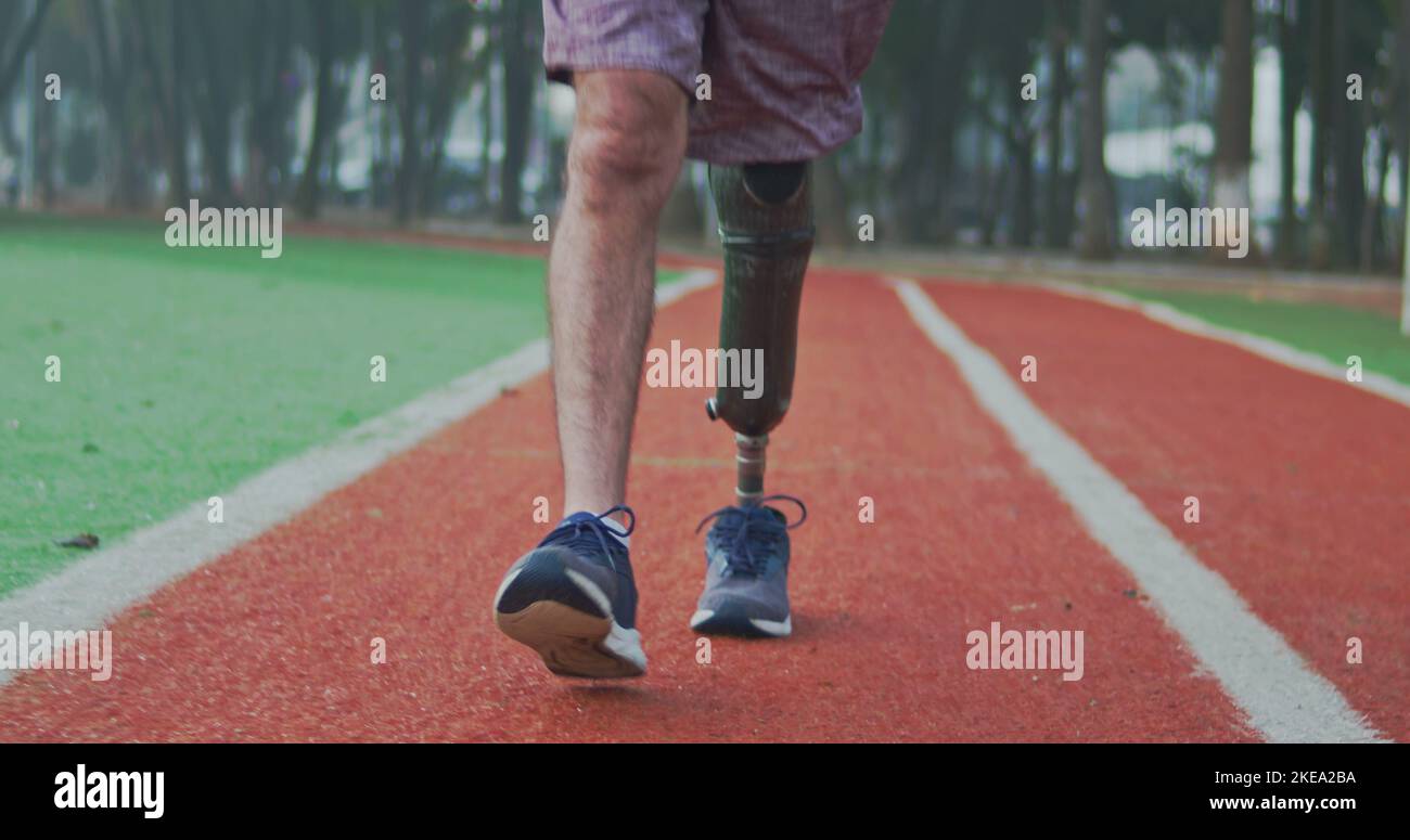 One disabled athlete walks outdoors with prosthetic leg. Male person ...