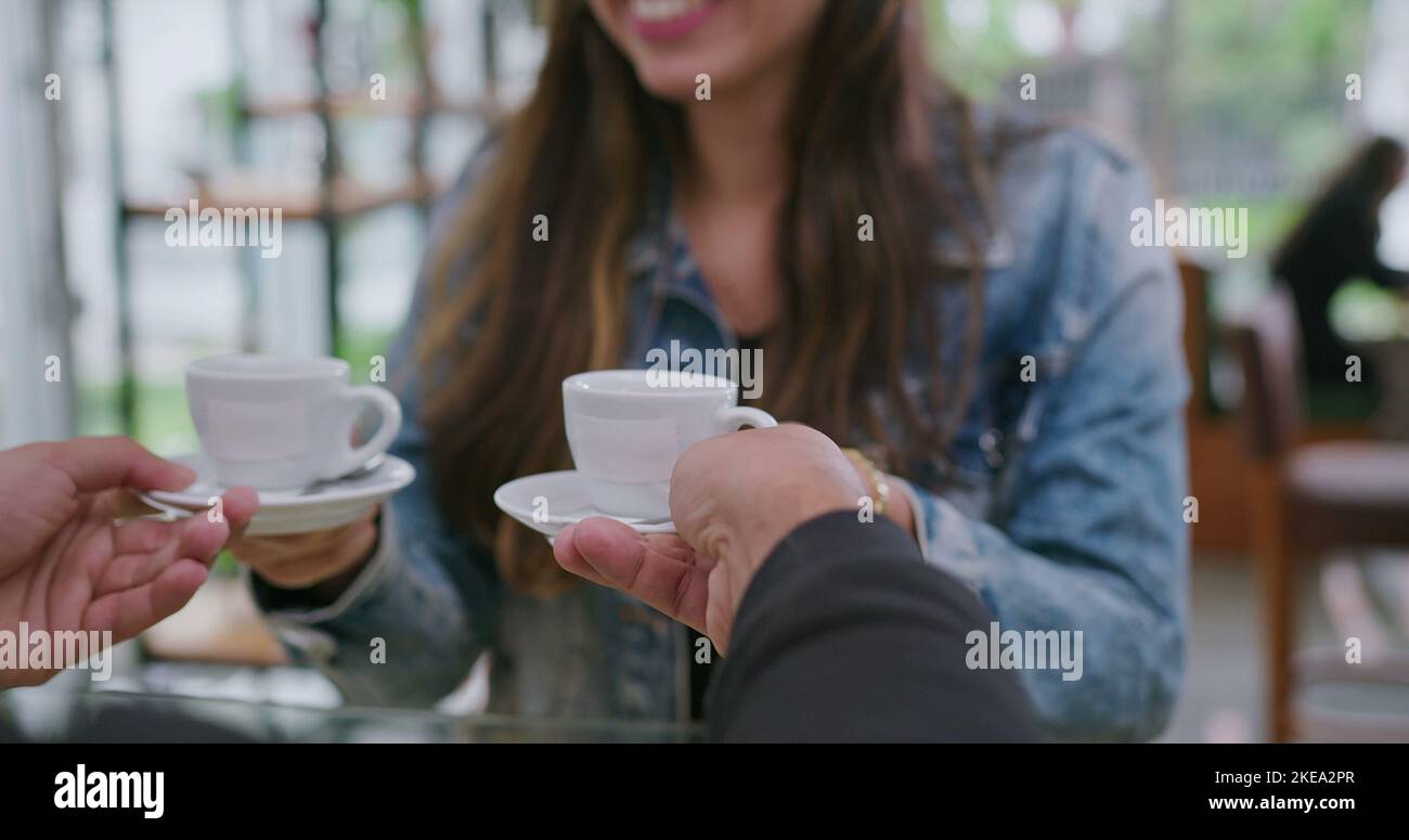 Female customer getting up from table and picking up two orders of ...