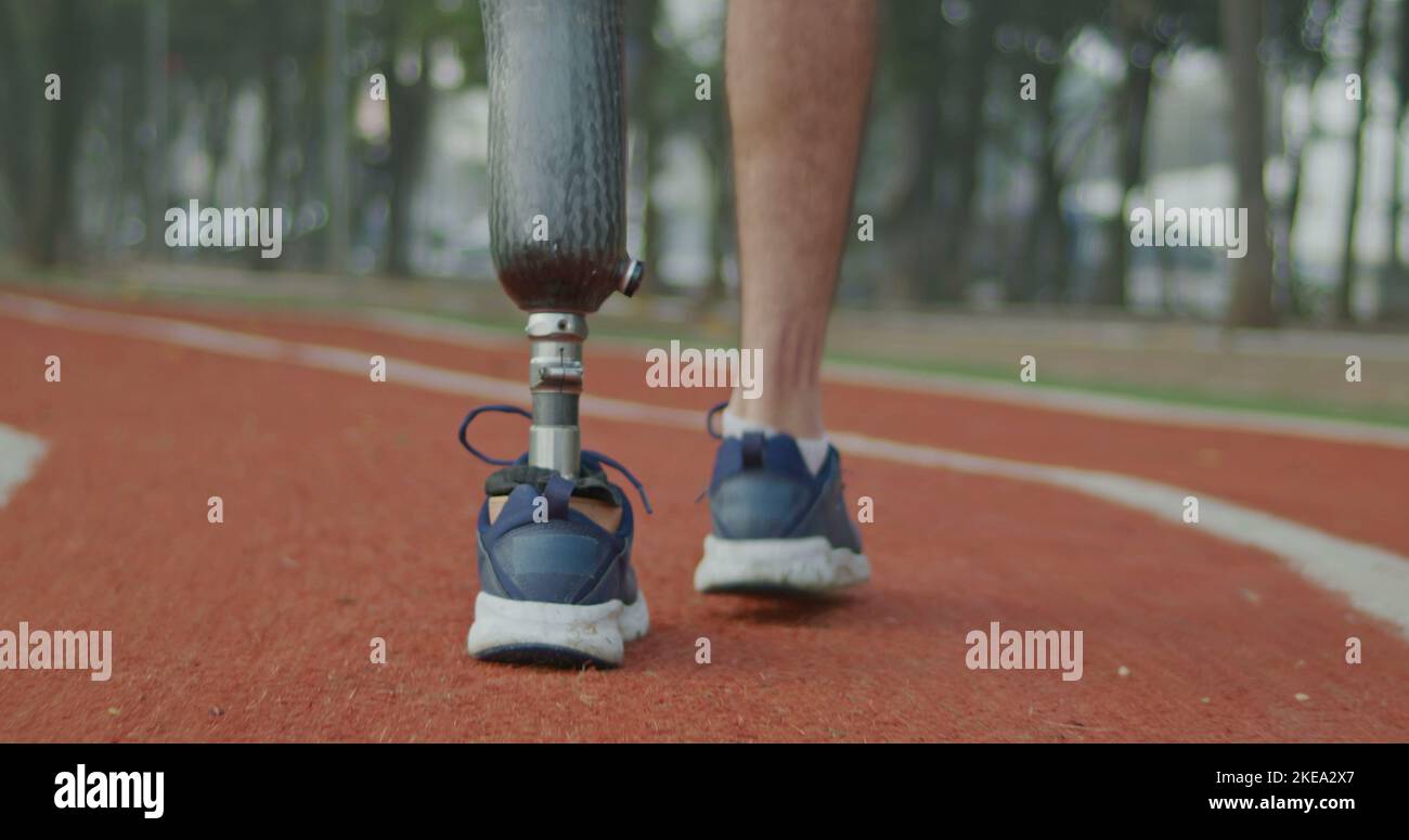 One disabled athlete walks outdoors with prosthetic leg. Male person ...