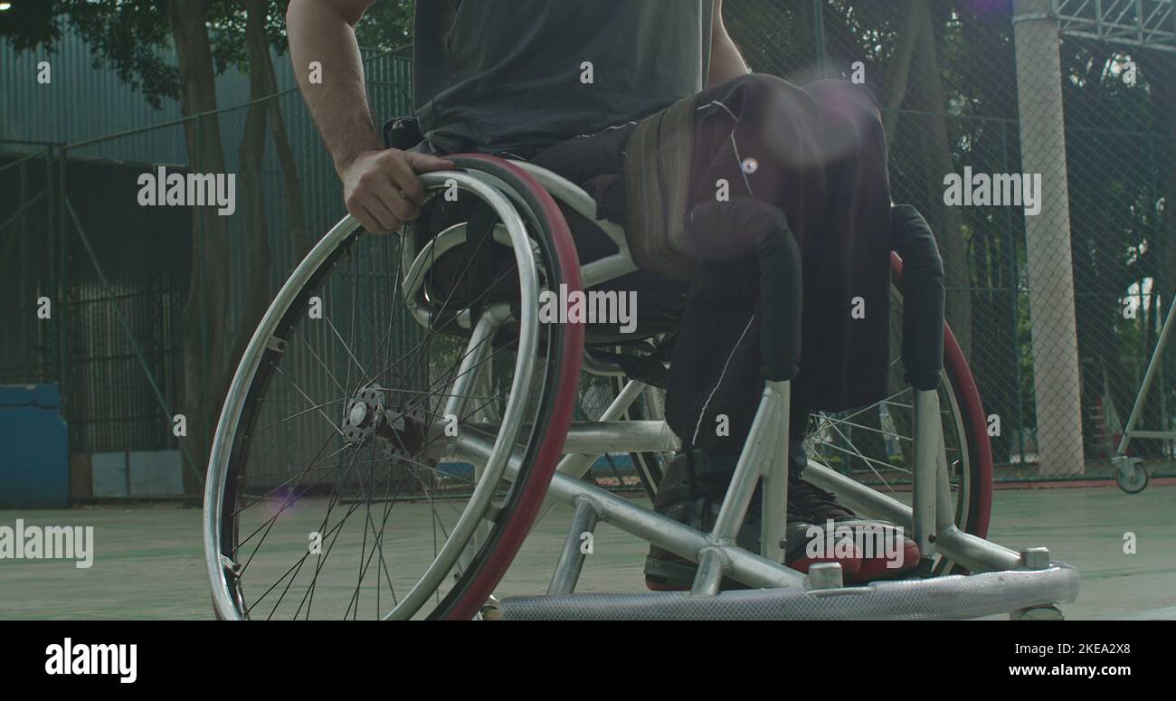 One disabled athlete on wheelchair closeup hands holding wheel outdoors ...