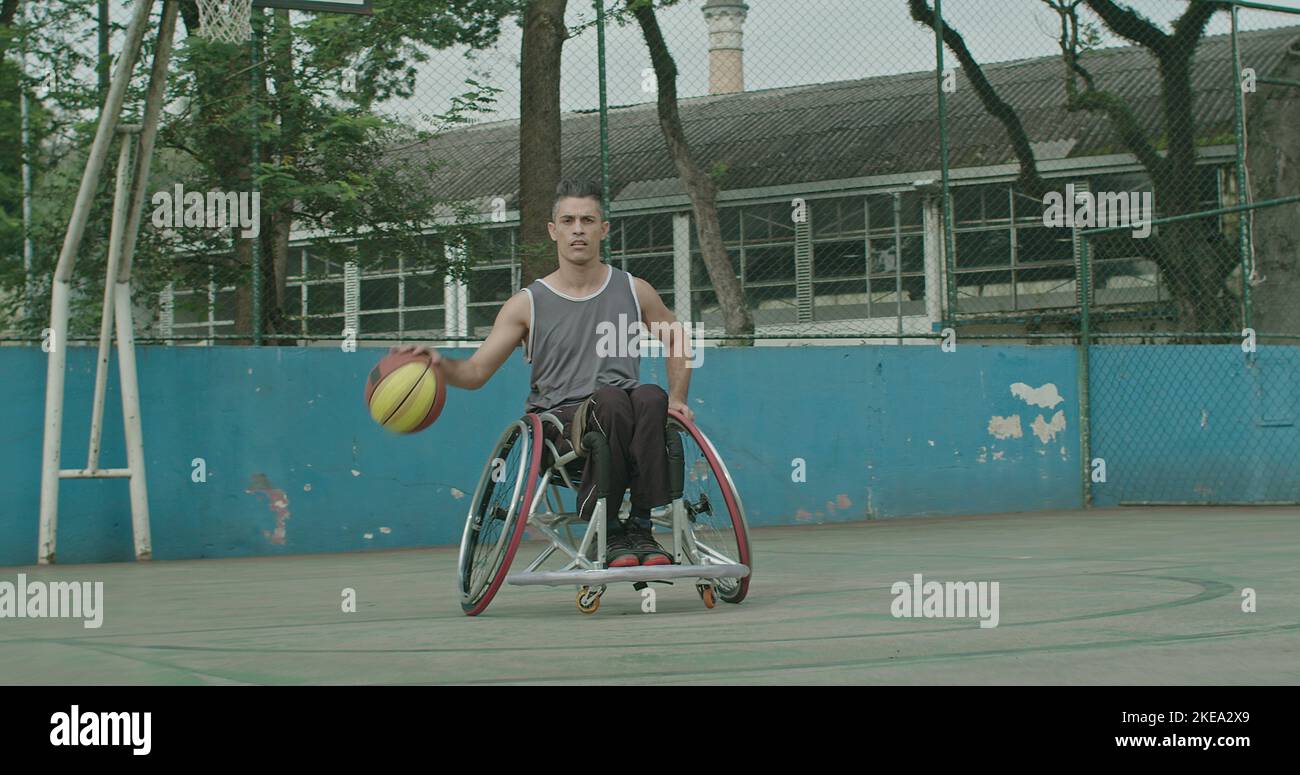 A paraplegic Brazilian basketball player on wheelchair playing ball ...