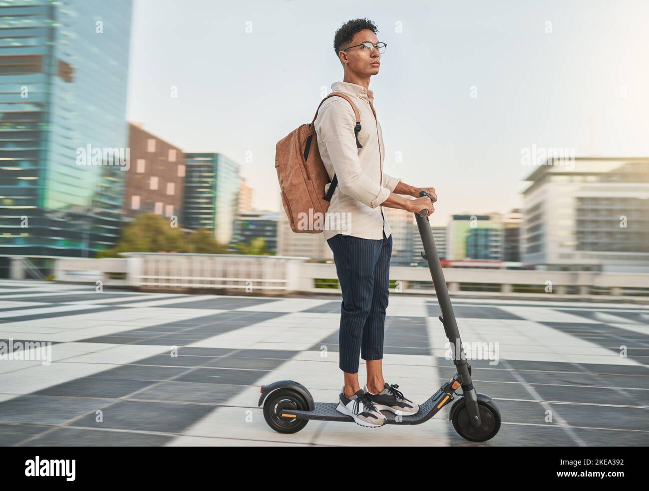 Travel, scooter and student in city, street or outdoors on road on eco ...