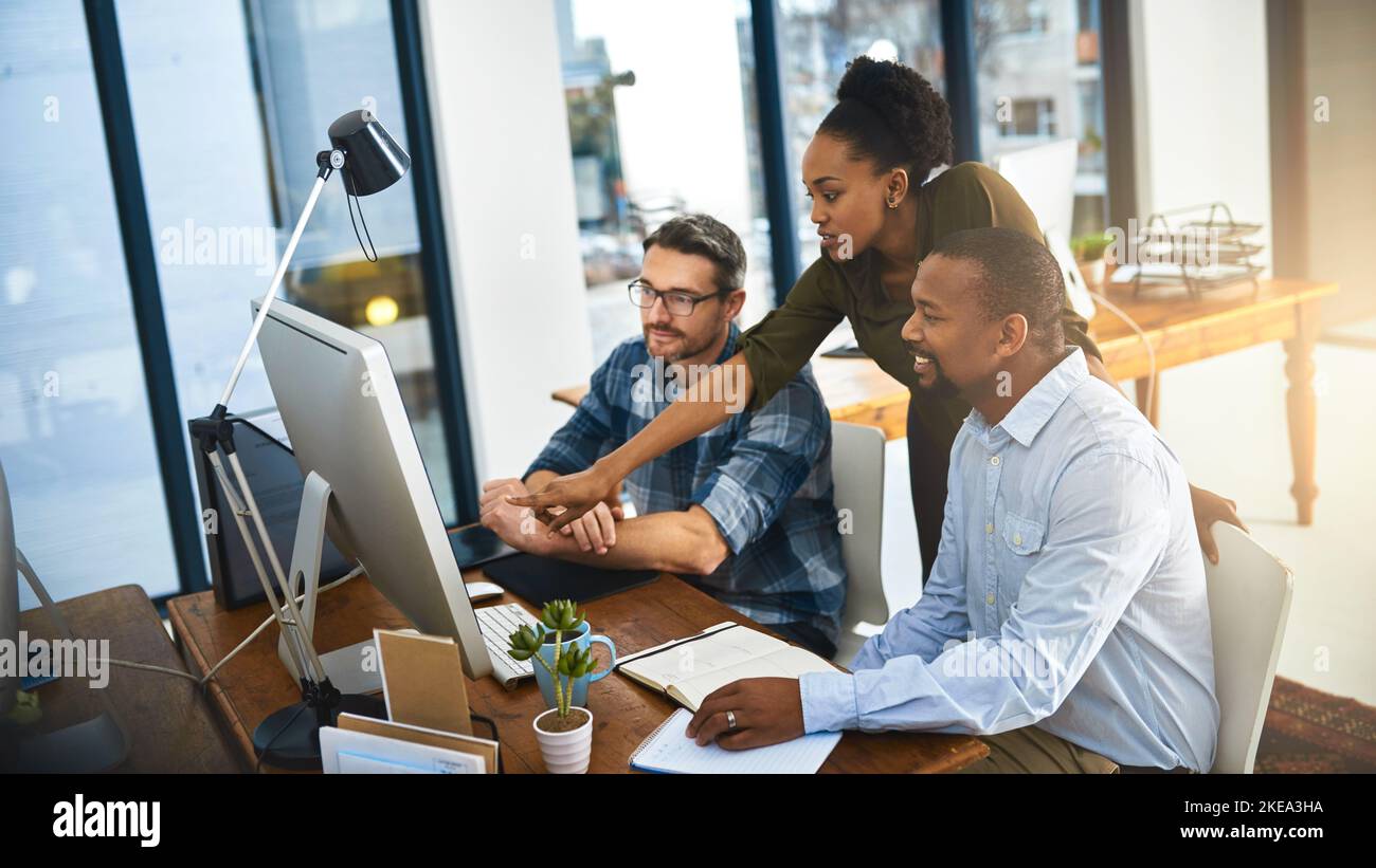 I like this...three businesspeople working around a computer in the ...
